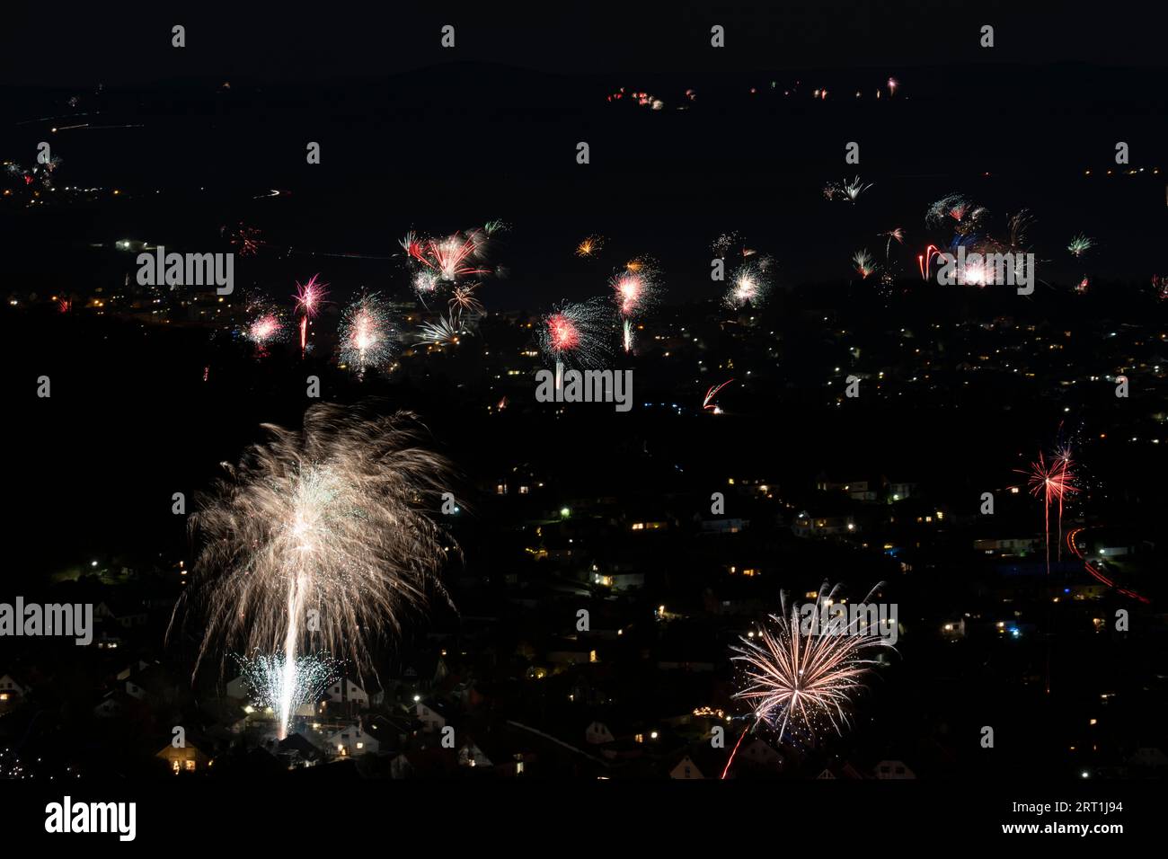 Night shot of a village with New Year's Eve fireworks with several ...