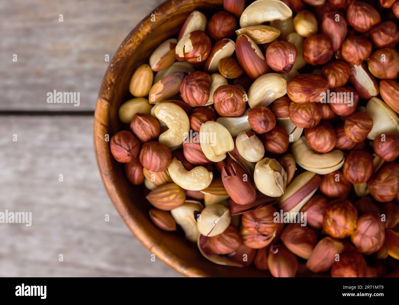 dried fruit inside bowl on antique wooden table Stock Photo - Alamy