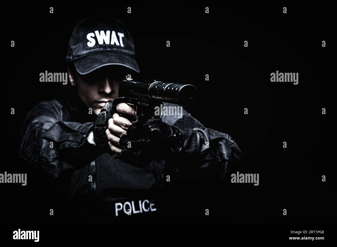 Spec ops police officer SWAT in black uniform aiming pistol with ...