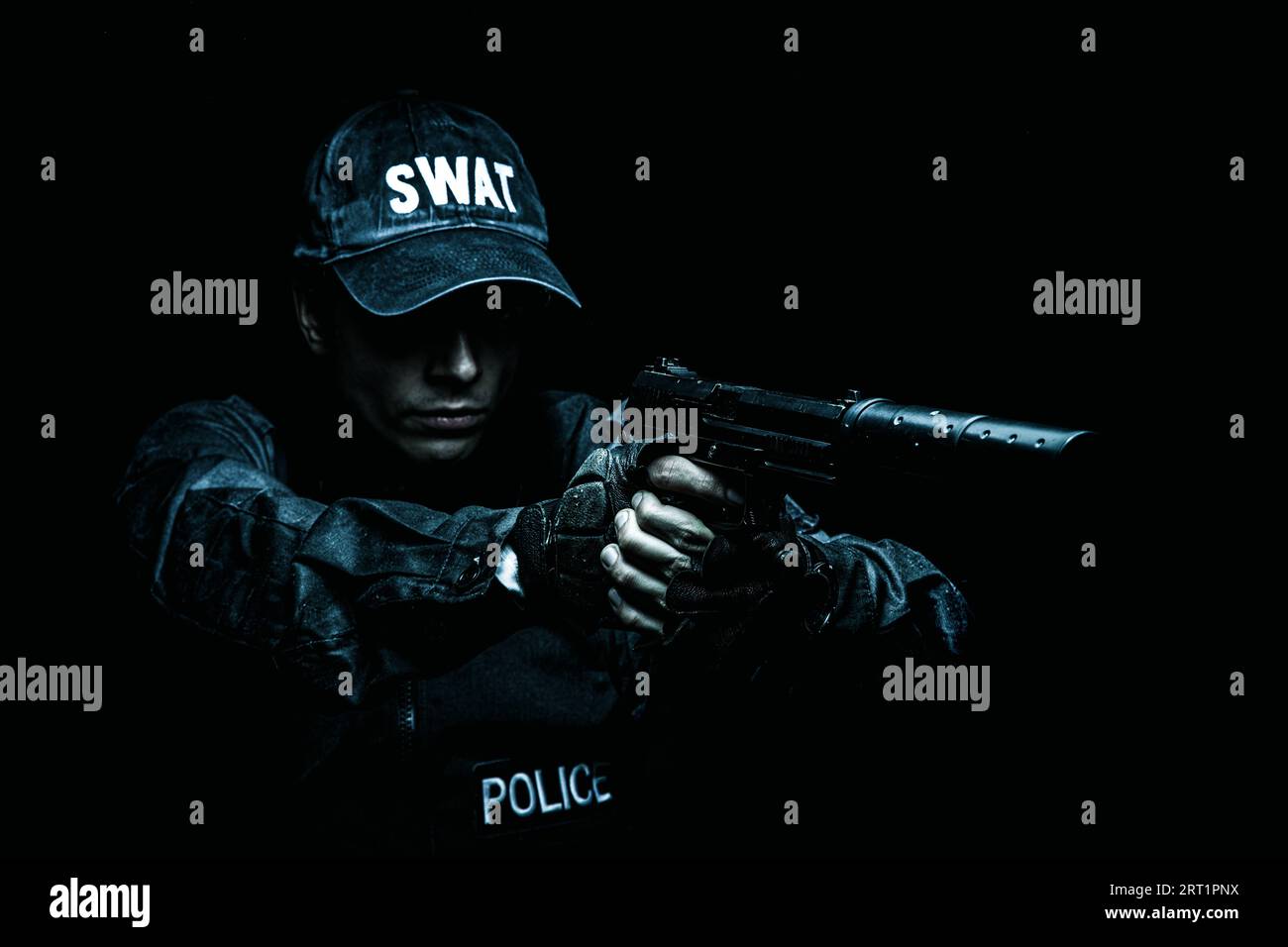 Spec ops police officer SWAT in black uniform aiming pistol with ...