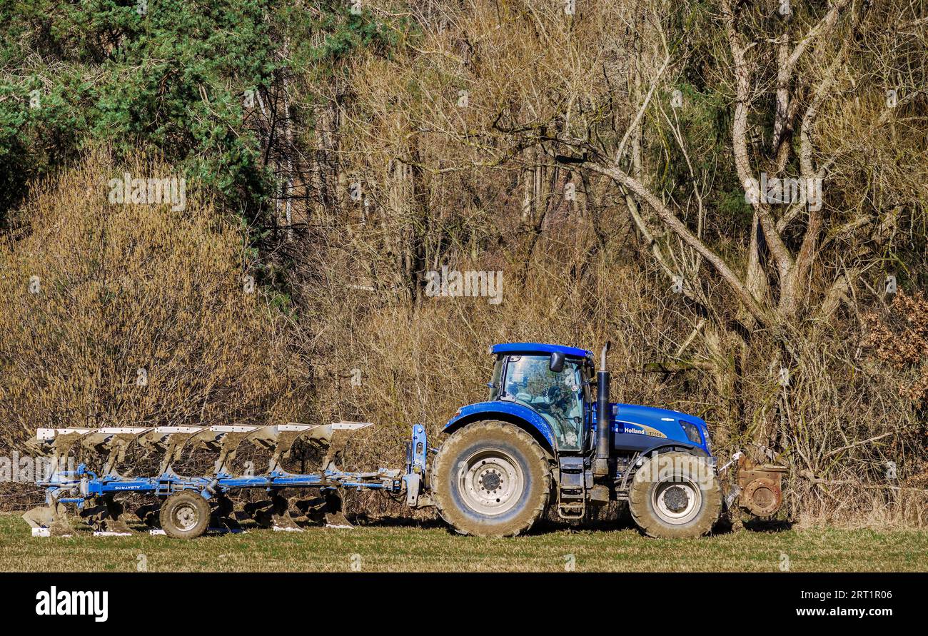 Parked the tractor in front of the forest edge Stock Photo - Alamy