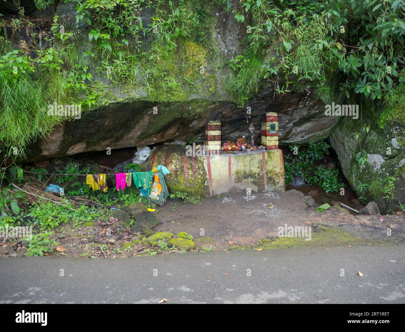 Colorful Hindu shrine under rocks in rainforest in Munnar, Kerala ...