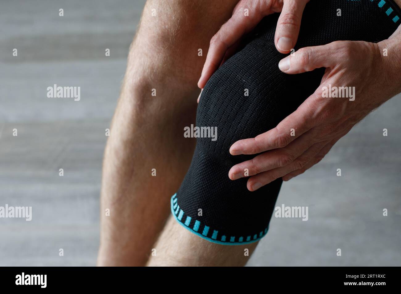 Knee Support Brace on male leg on grey background. Elastic Orthopedic ...
