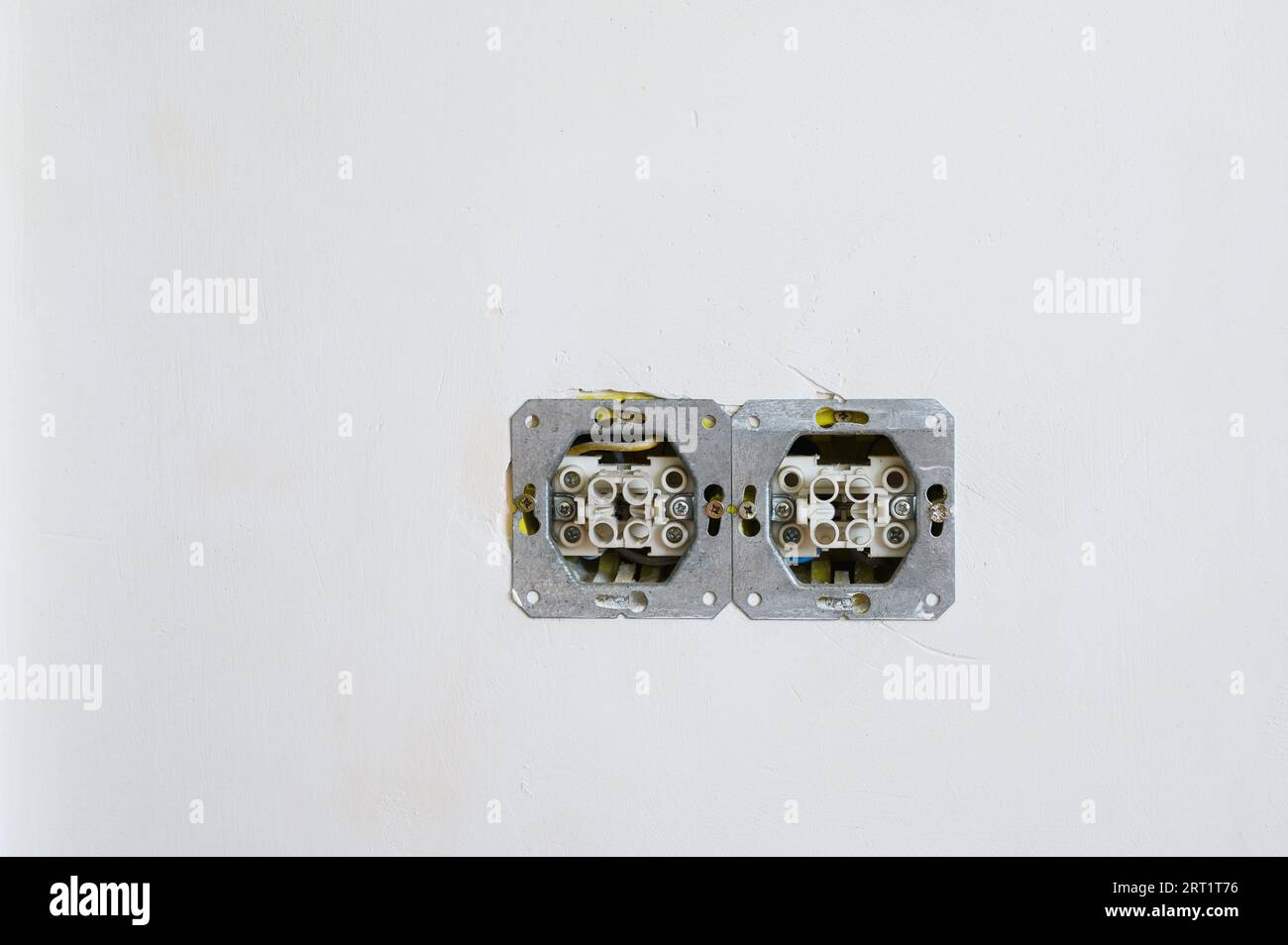 Double open euro electrical socket on a grungy gray wall. Close-up ...