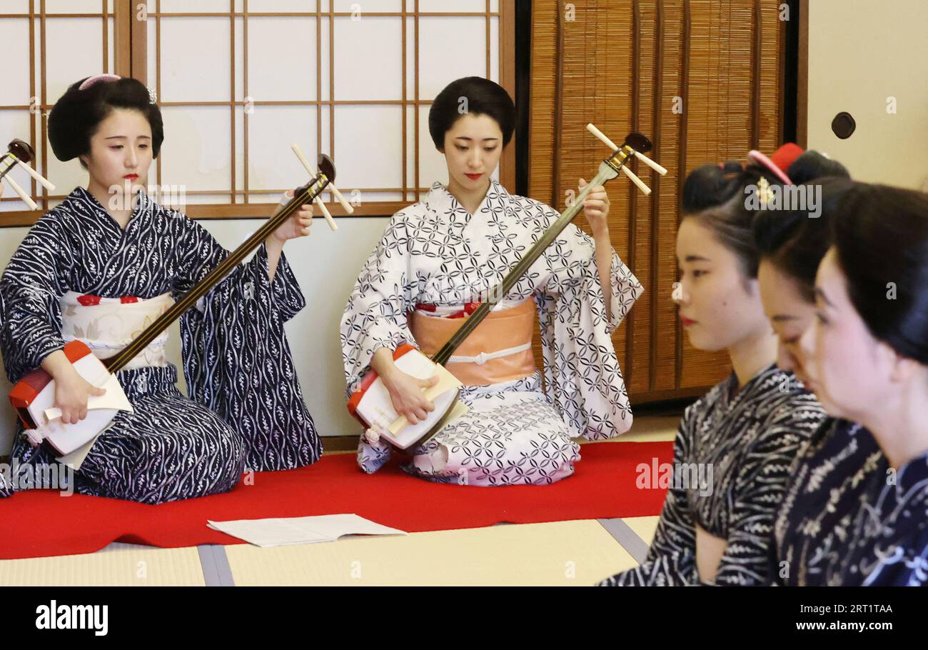 Geisha and maiko play shamisen during an event "Yukata-kai" in Kyoto ...