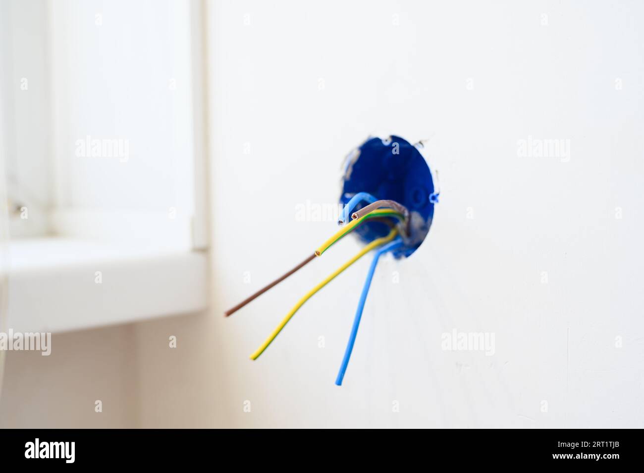 Preparing to install the socket in the wall. Electrical wires sticking ...