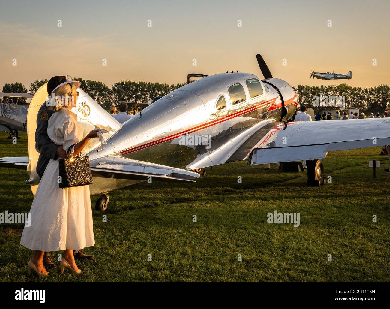 A Spitfire flies as the sun sets during the Goodwood Revival at the ...
