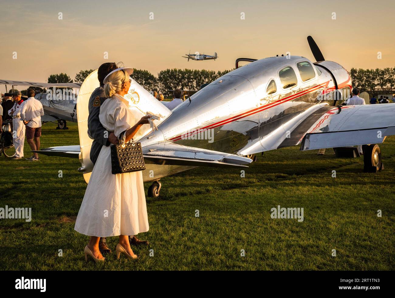 A Spitfire flies as the sun sets during the Goodwood Revival at the ...
