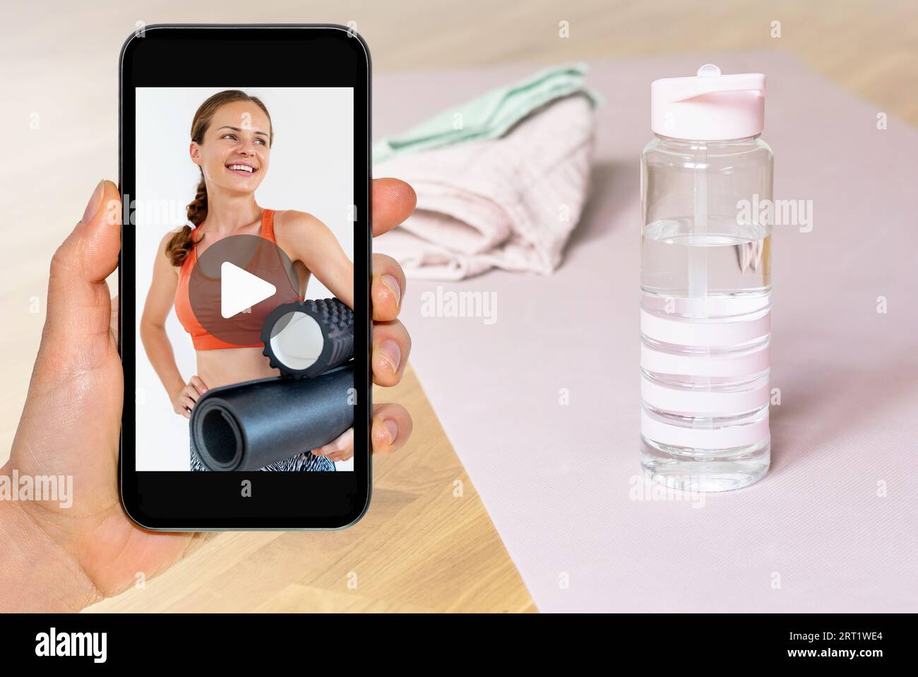 Online video workout, female fitness coach on screen of smart phone in ...