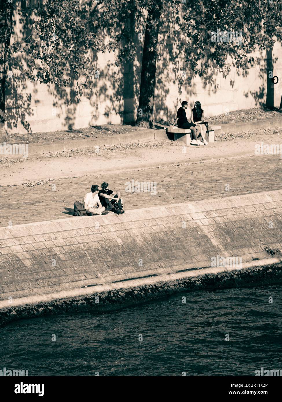 B&W People relaxing on the River Seine River Bank, Île Saint-Louis, Island in the Seine, Paris ...