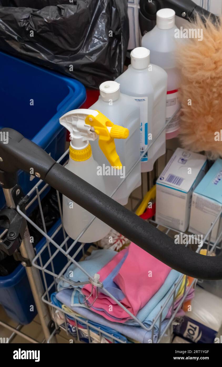 Commercial cleaning trolley stocked with cleaning spray, cloths ...