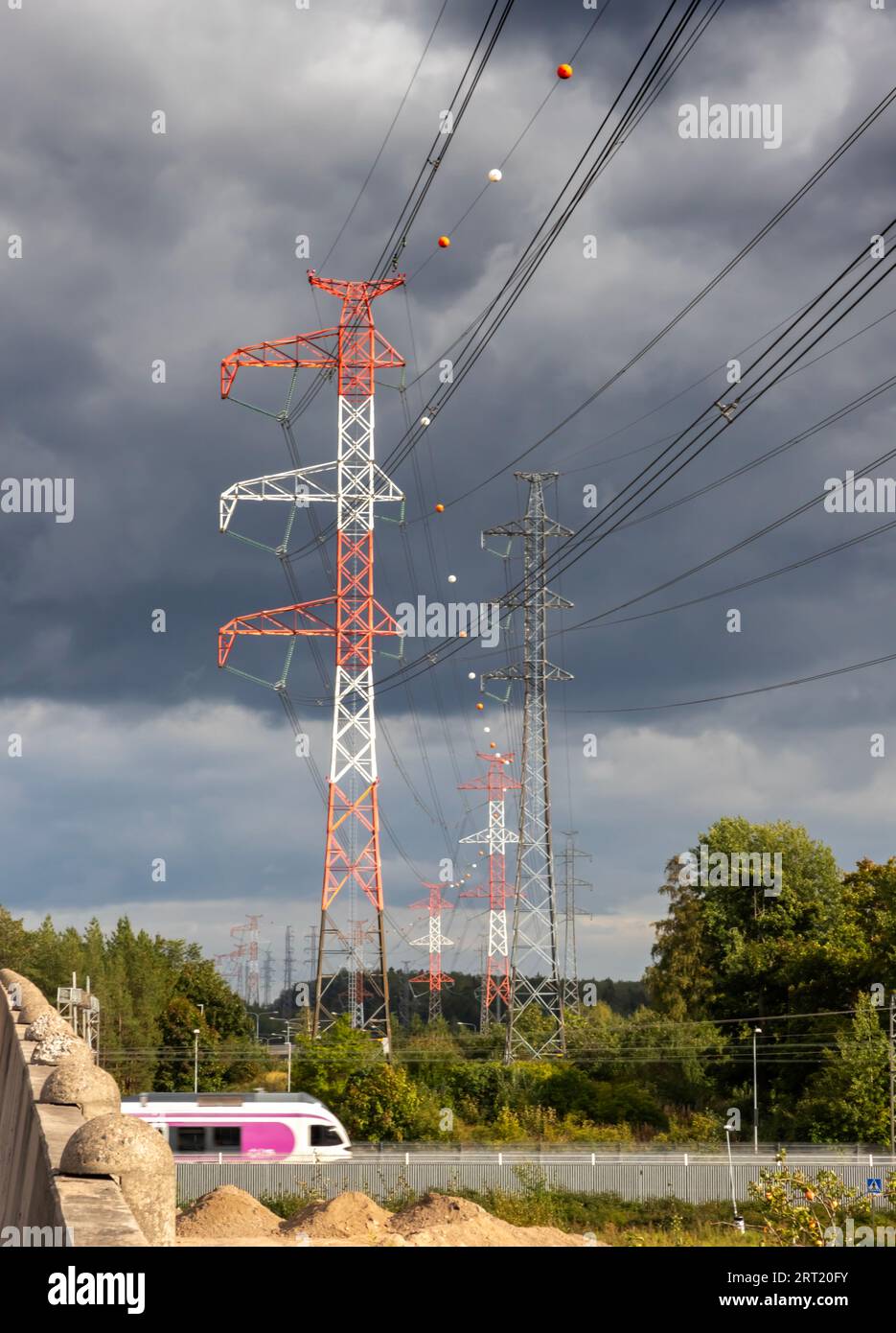 Overhead power lines being passed by a Stadler Flirt multiple unit trainset operated by Helsinki ...