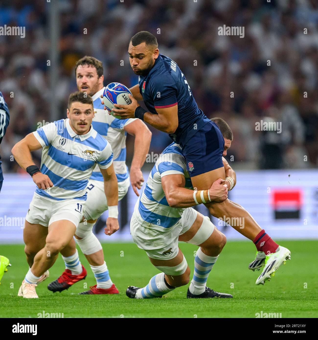Joe Marchant of England is tackled by Marcos Kremer of Argentina during ...
