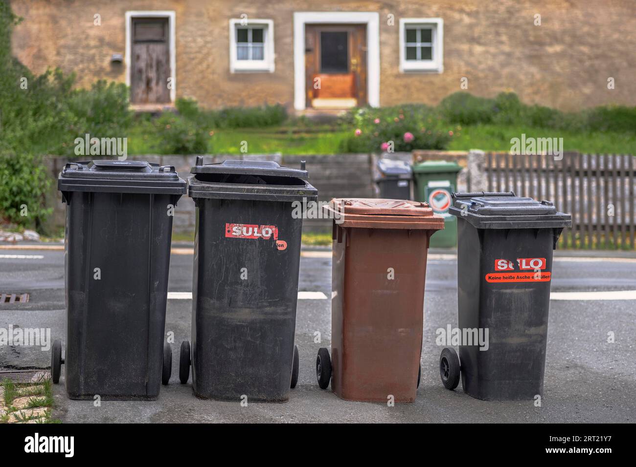 Waste bins - lined up in a row Stock Photo - Alamy