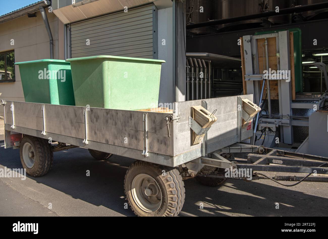 Harvest vehicle with grape vats in front of a wine press house Stock ...