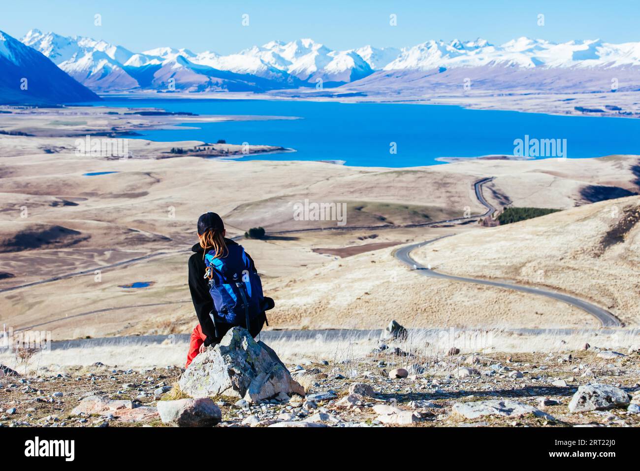 A hiker admires the view of the southern alps and Lake Alexandrina from ...