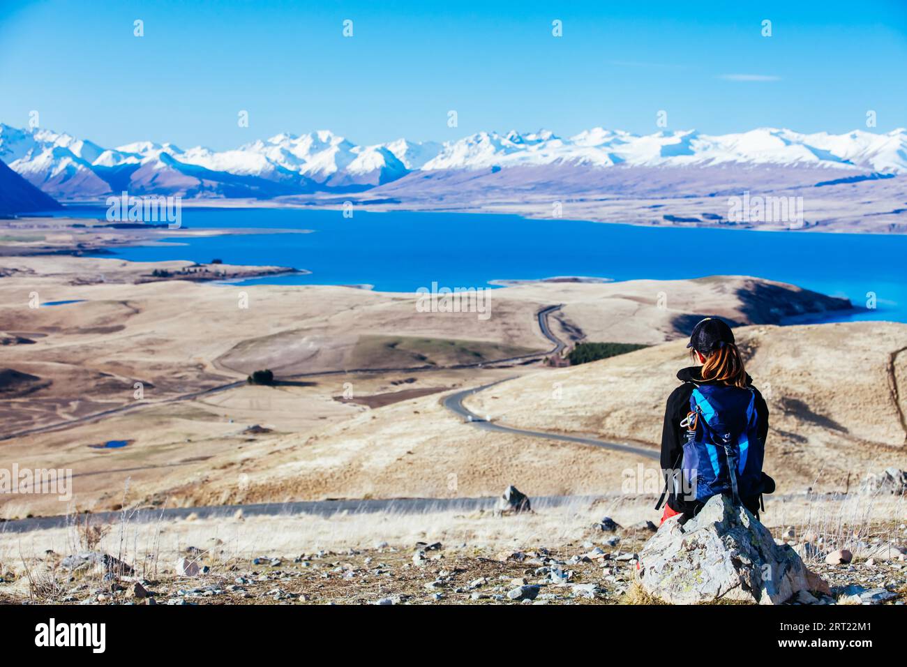 A hiker admires the view of the southern alps and Lake Alexandrina from ...