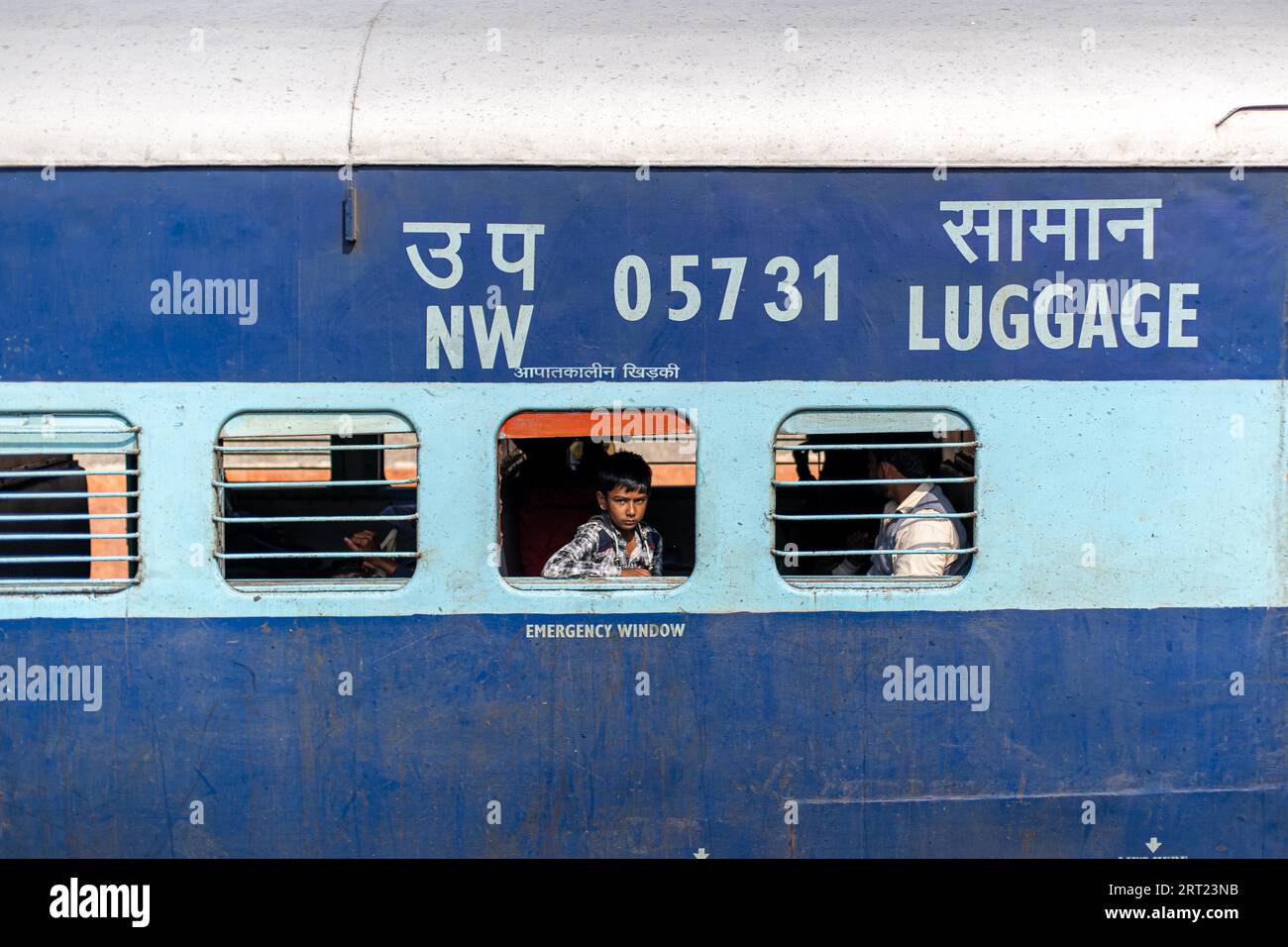 Jodhpur, India, Decembe 10, 2019: A boy looking out of a window of an ...