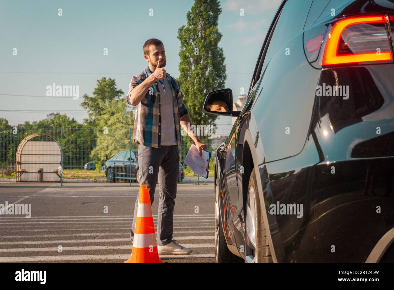 Male instructor showing thumbs up for woman after passing exams ...