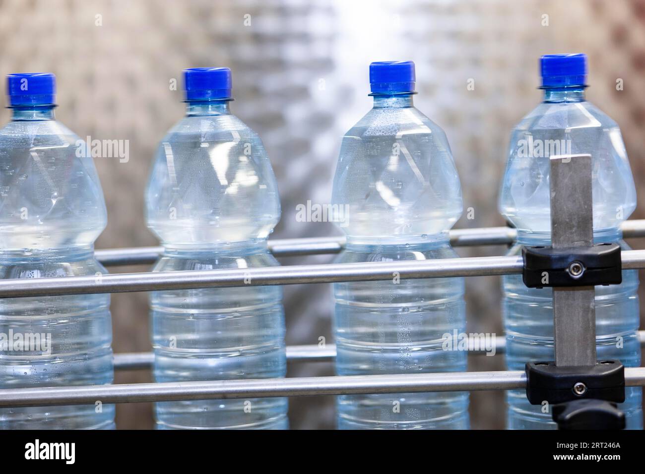 PET bottles on an assembly line in a mineral water factory, Haan ...