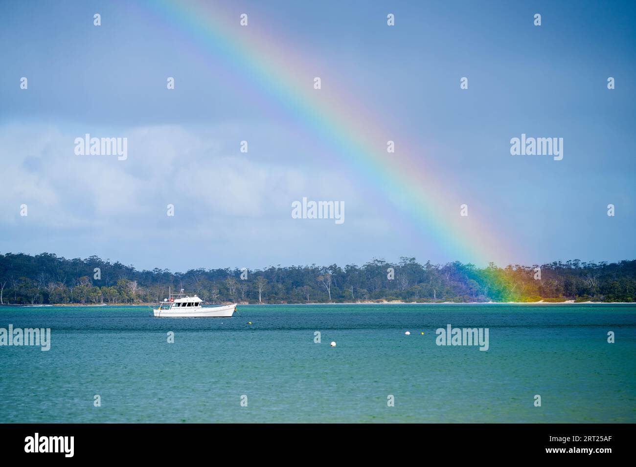 rainbow over the ovean and above an island in australia Stock Photo - Alamy