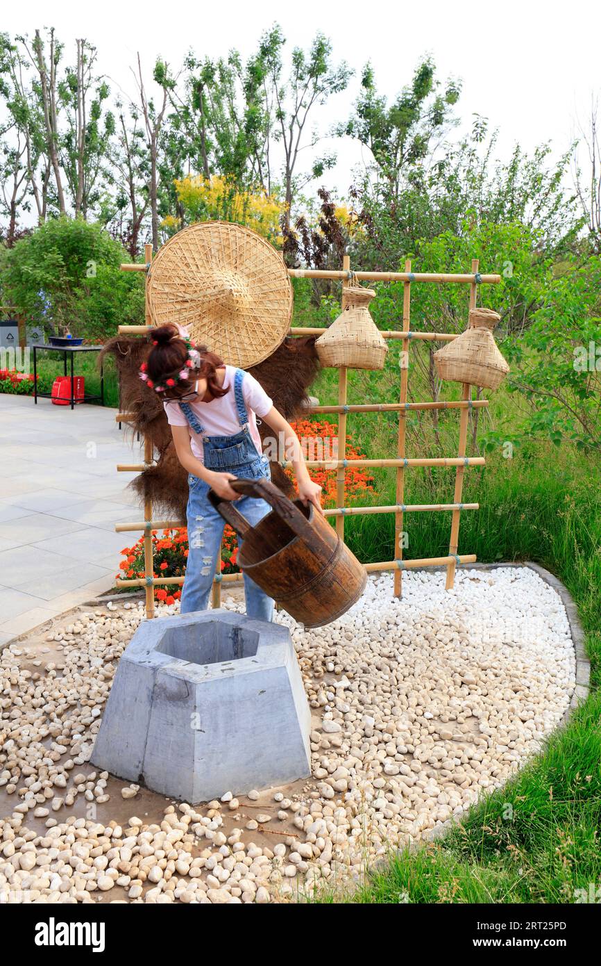 Girl carrying a bucket hi-res stock photography and images - Alamy