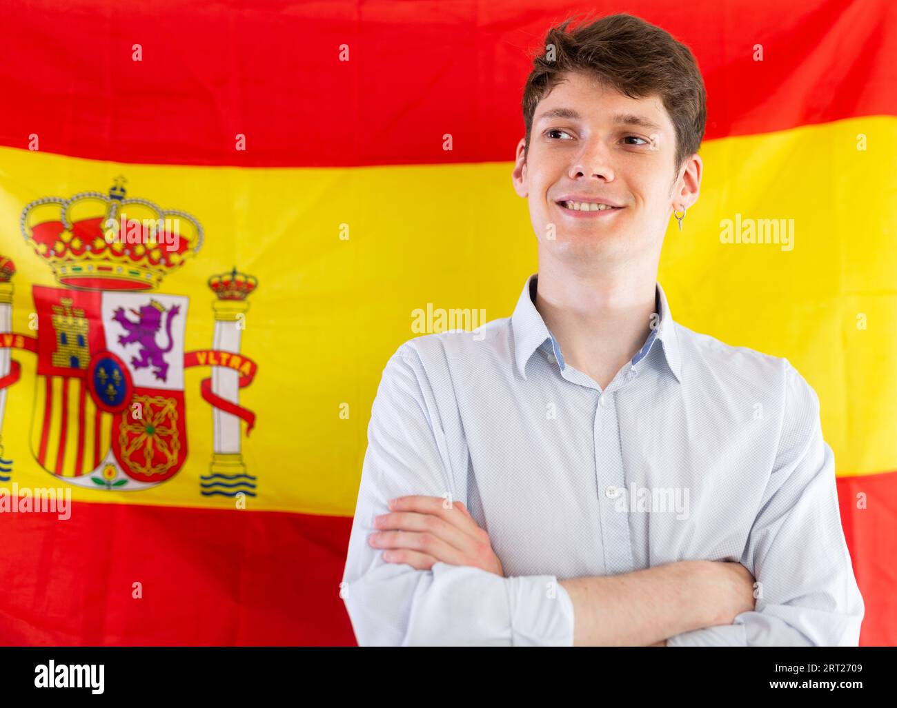 Portrait of positive student against background of flag of Spain ...