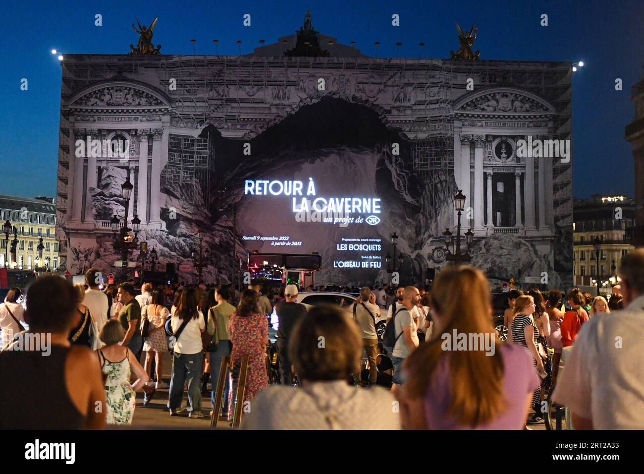 People in front of an installation by French artist JR, depicting the ...