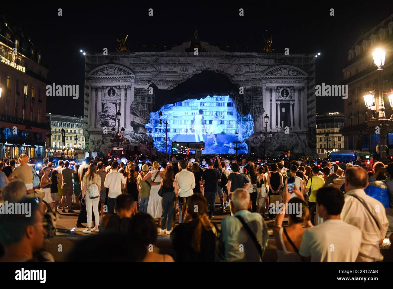 People in front of an installation by French artist JR, depicting the ...
