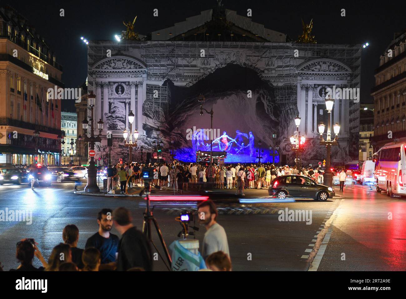 People in front of an installation by French artist JR, depicting the ...