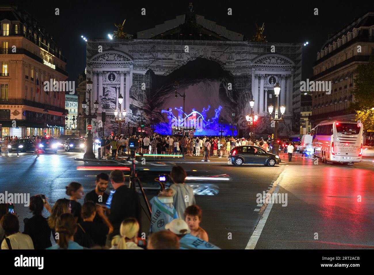 People in front of an installation by French artist JR, depicting the ...