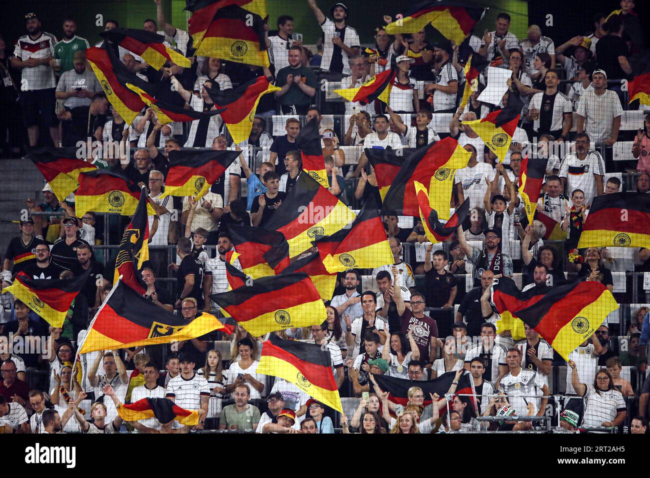 WOLFSBURG - Germany fans with the national flag during the friendly ...