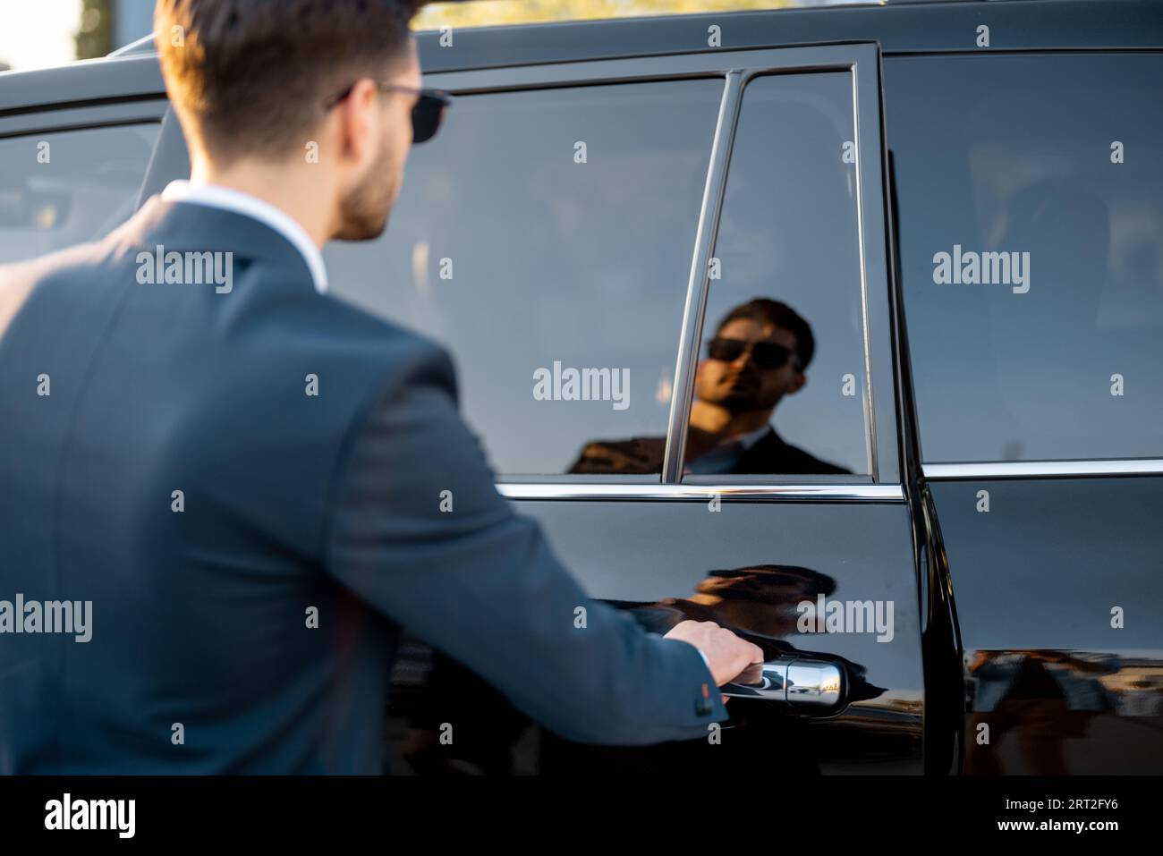 Businessman opening vehicle door Stock Photo - Alamy Businessman opening vehicle door Stock Photo - Alamy