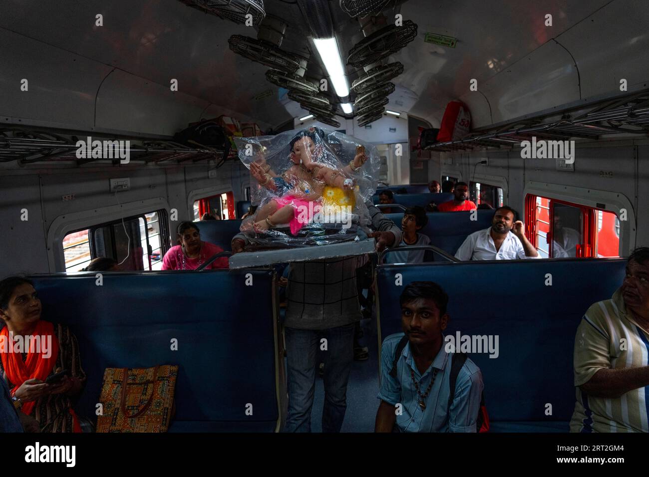A clay idol of elephant headed Hindu god Ganesh is carried inside a ...