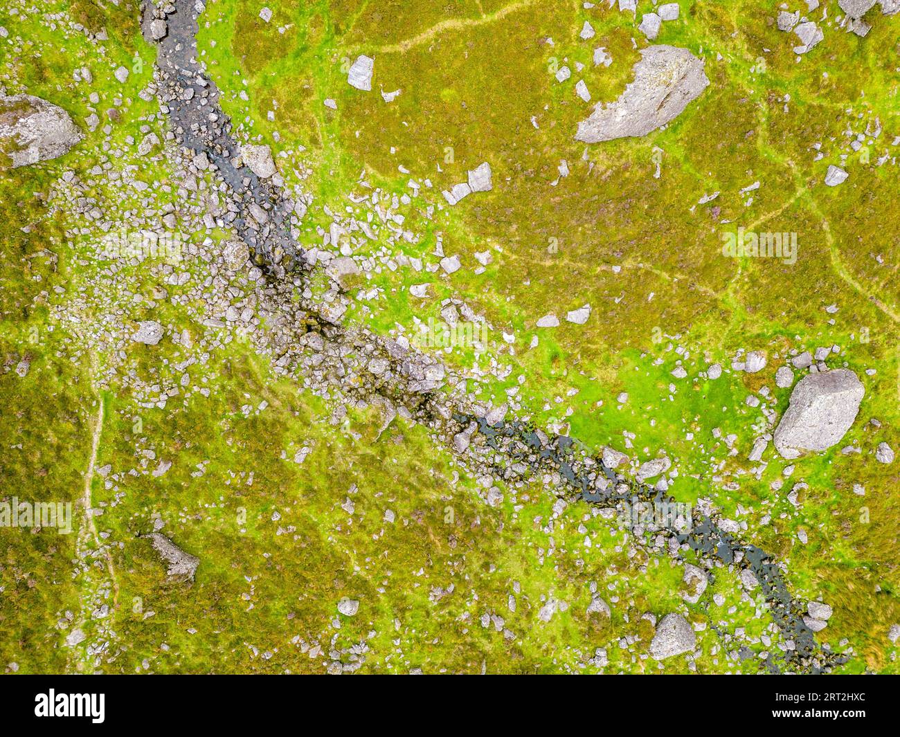 Aerial view of small river in Coumshingaun Lough with rocks and ...