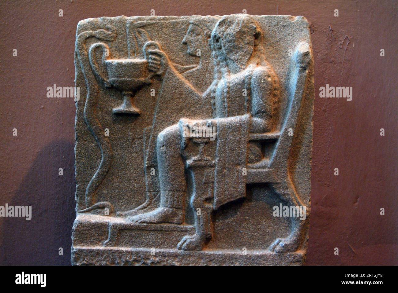 Carved stone of a figure holding a vessel, possibly Etruscan, at the ...
