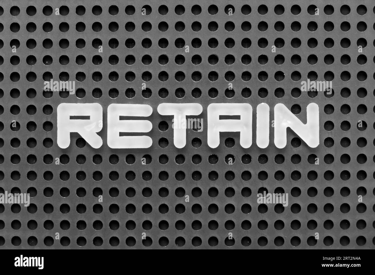 White alphabet letter in word retain on black pegboard background Stock ...
