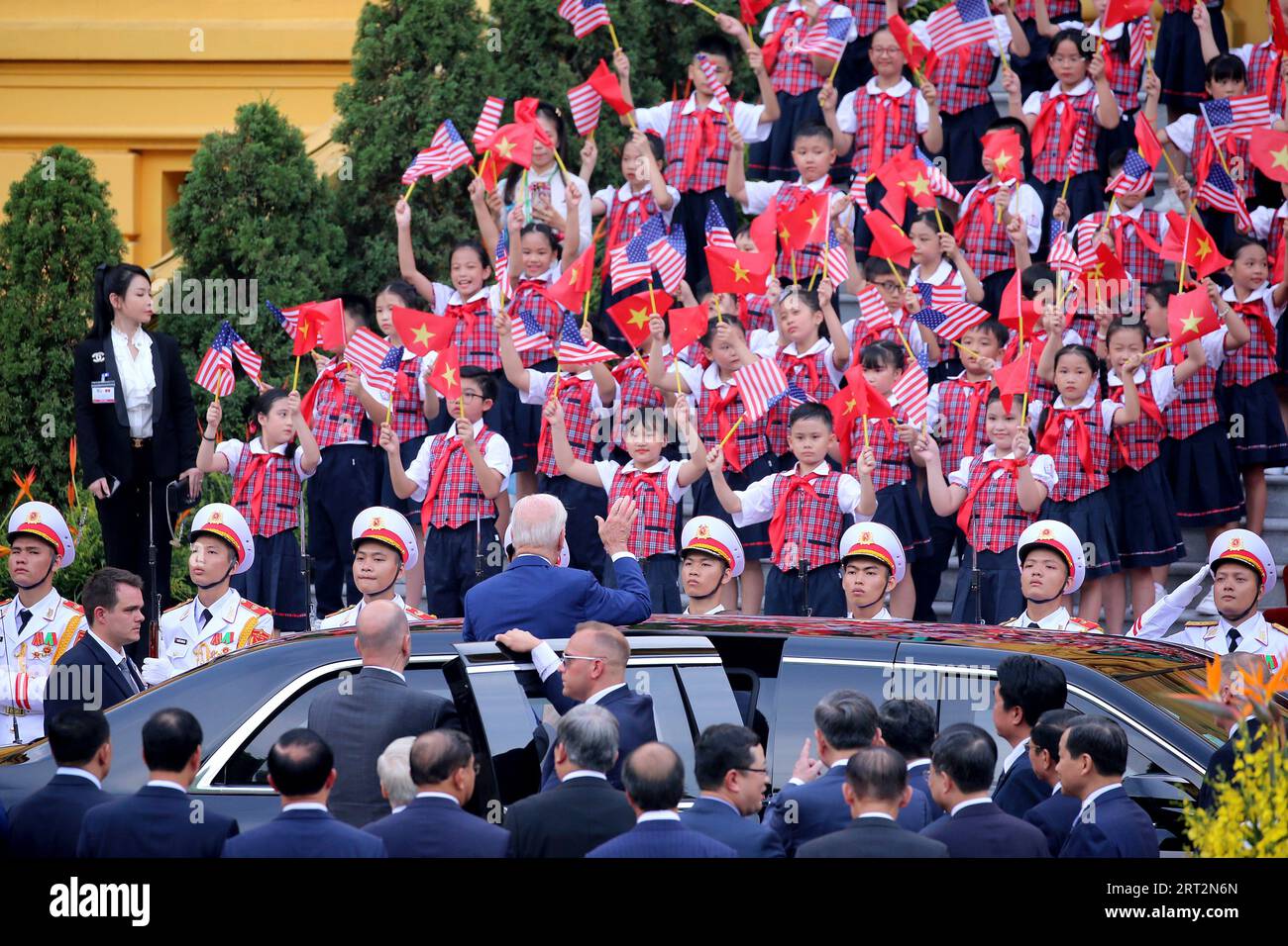 US President Joe Biden waves to the children after a military welcome ...