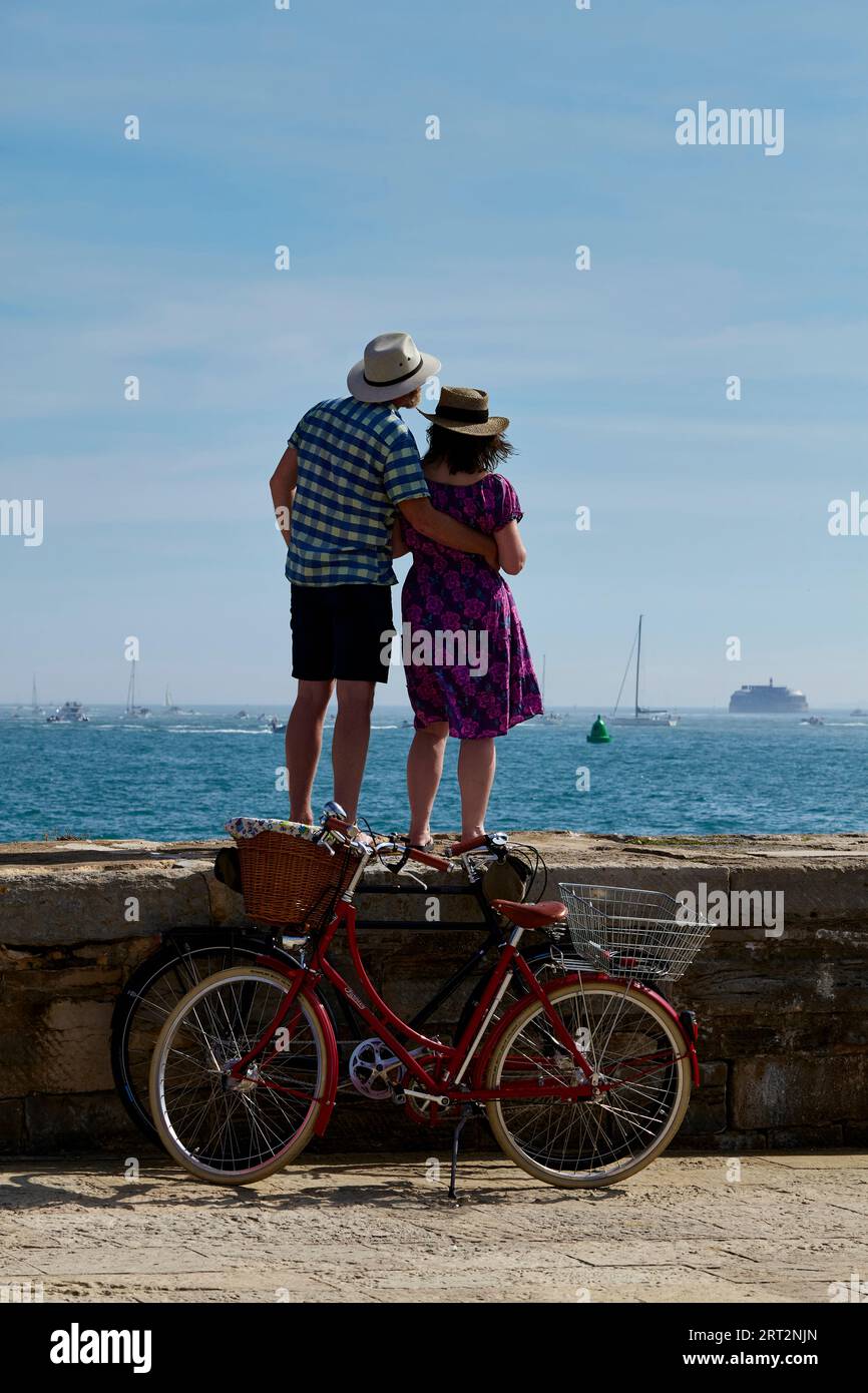 Man holds woman around waist standing on sea defences at Portsmouth ...