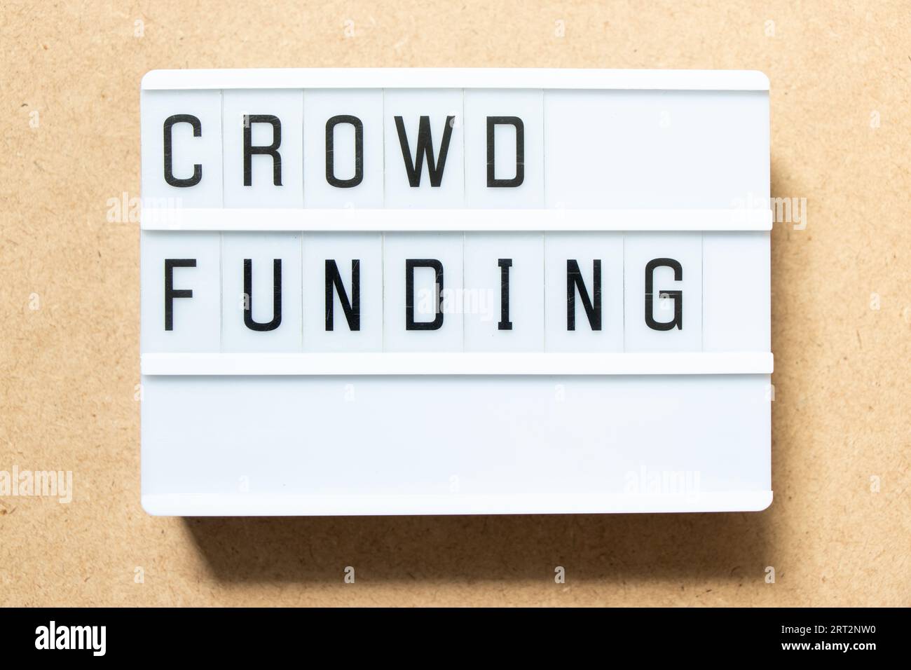 Lightbox with word crowd funding on wood background Stock Photo - Alamy