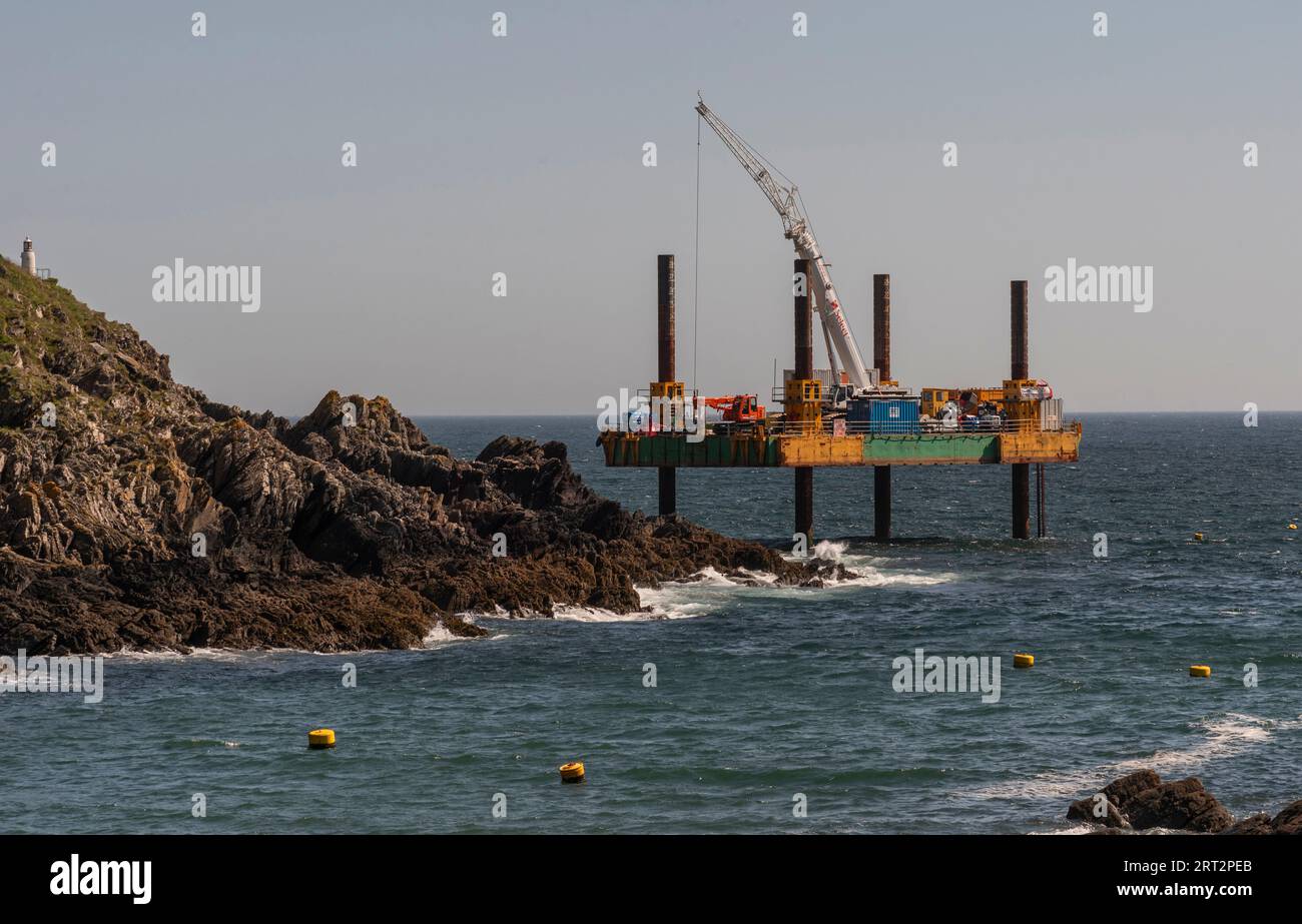 Polperro, Cornwall, England, UK. September 2023. Remedial work being carried out from a jack up ...