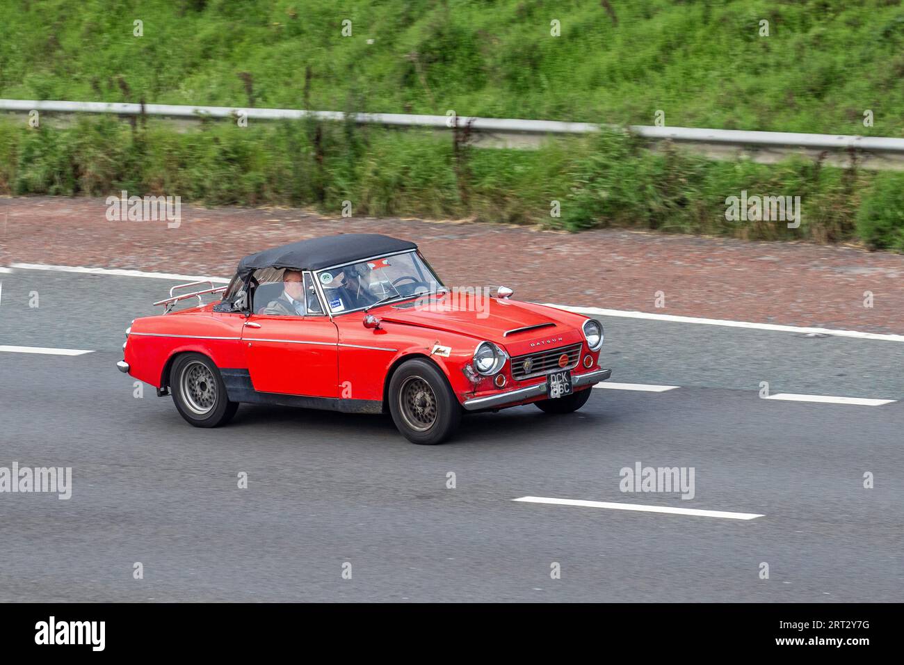 1965 60s sixties Red DATSUN 1600cc petrol cabriolet; travelling at ...