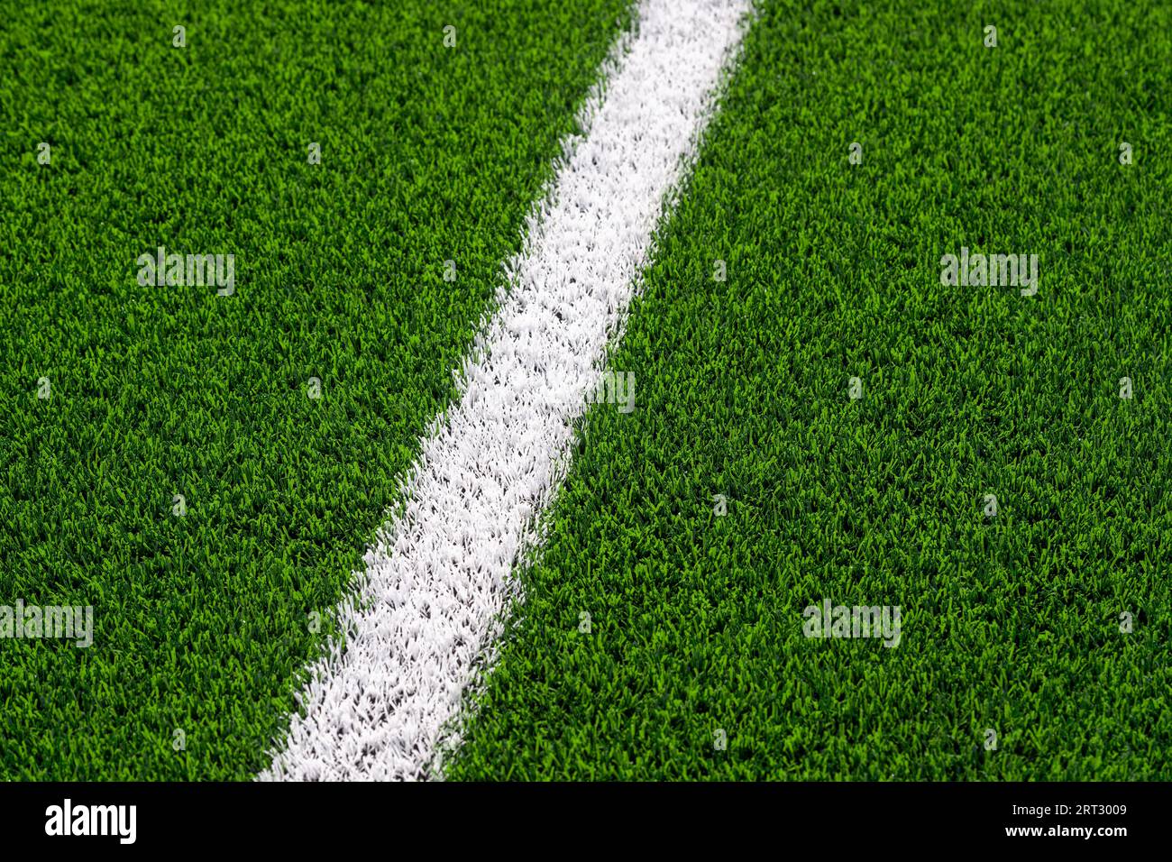 Green synthetic grass sports field with white line shot from above ...