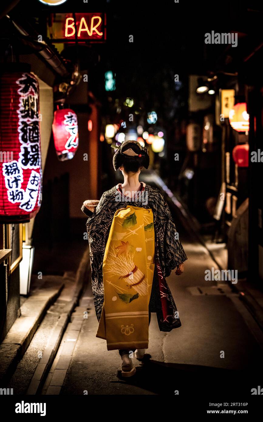 A Geisha wallks down Pontocho Alley at night in central Kyoto japan ...