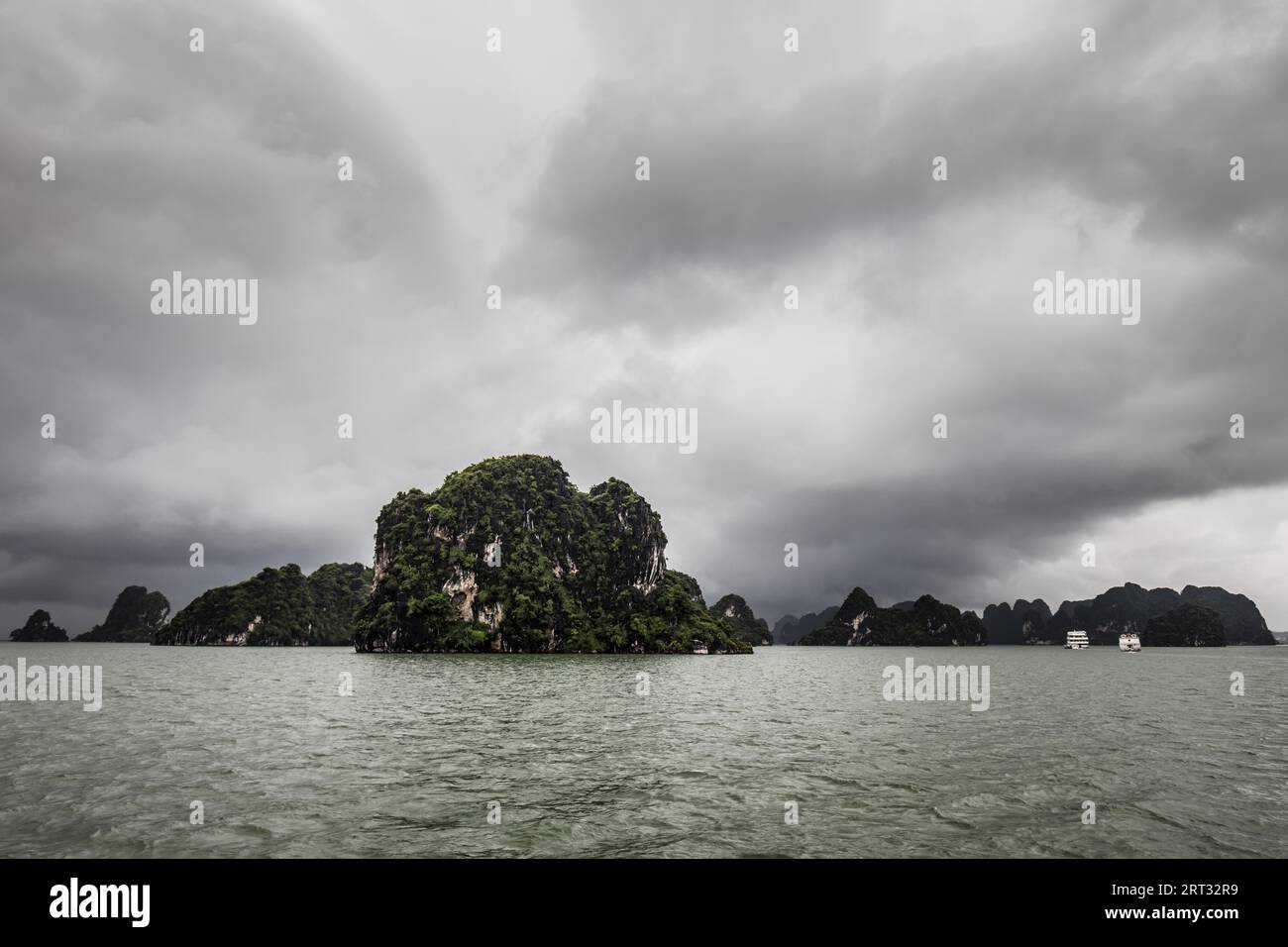 View throughout the islands of Ha Long Bay on a stormy summer's day in ...