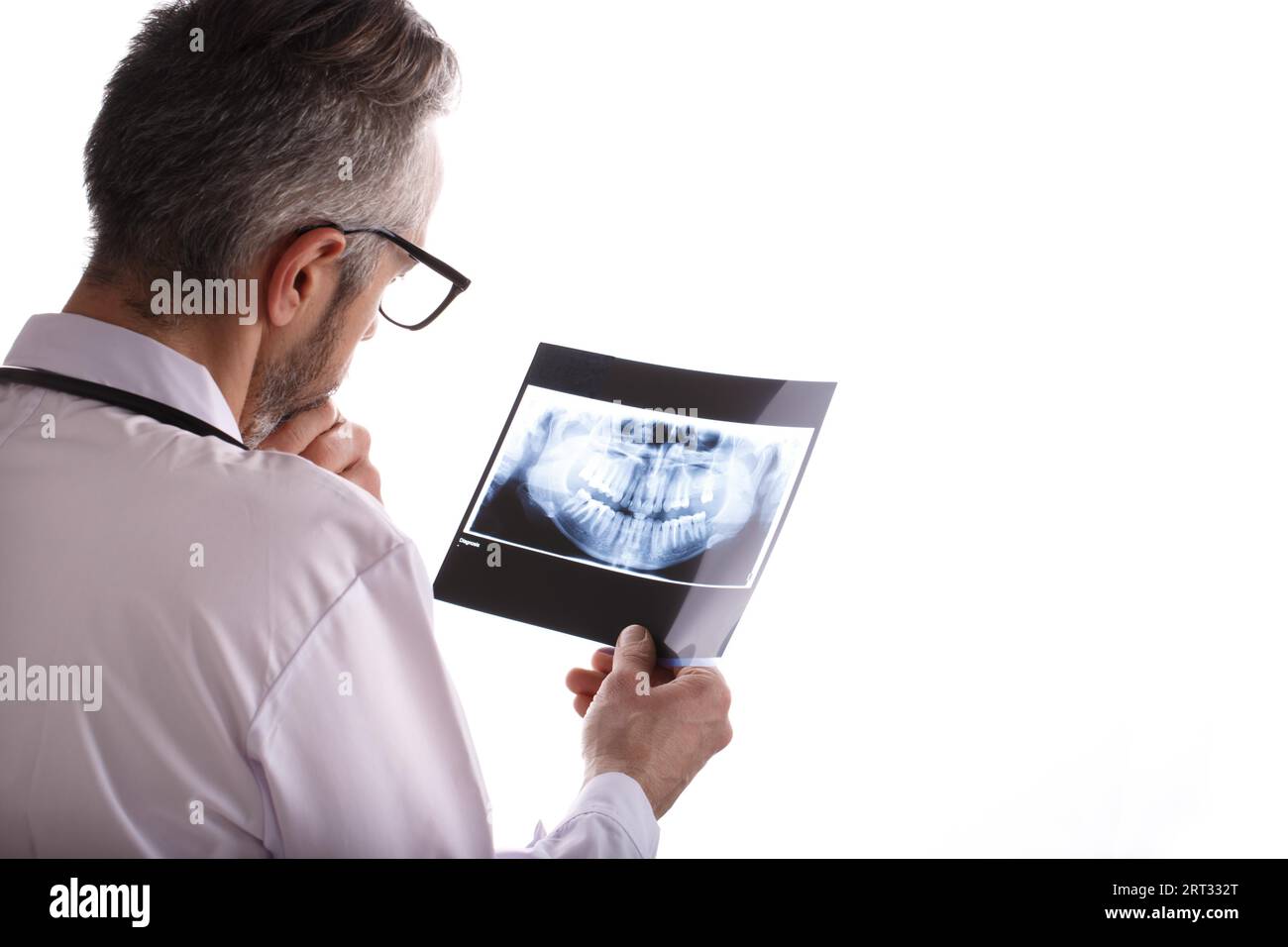Doctor dentist looking and examining panoramic dental X-ray, isolated ...