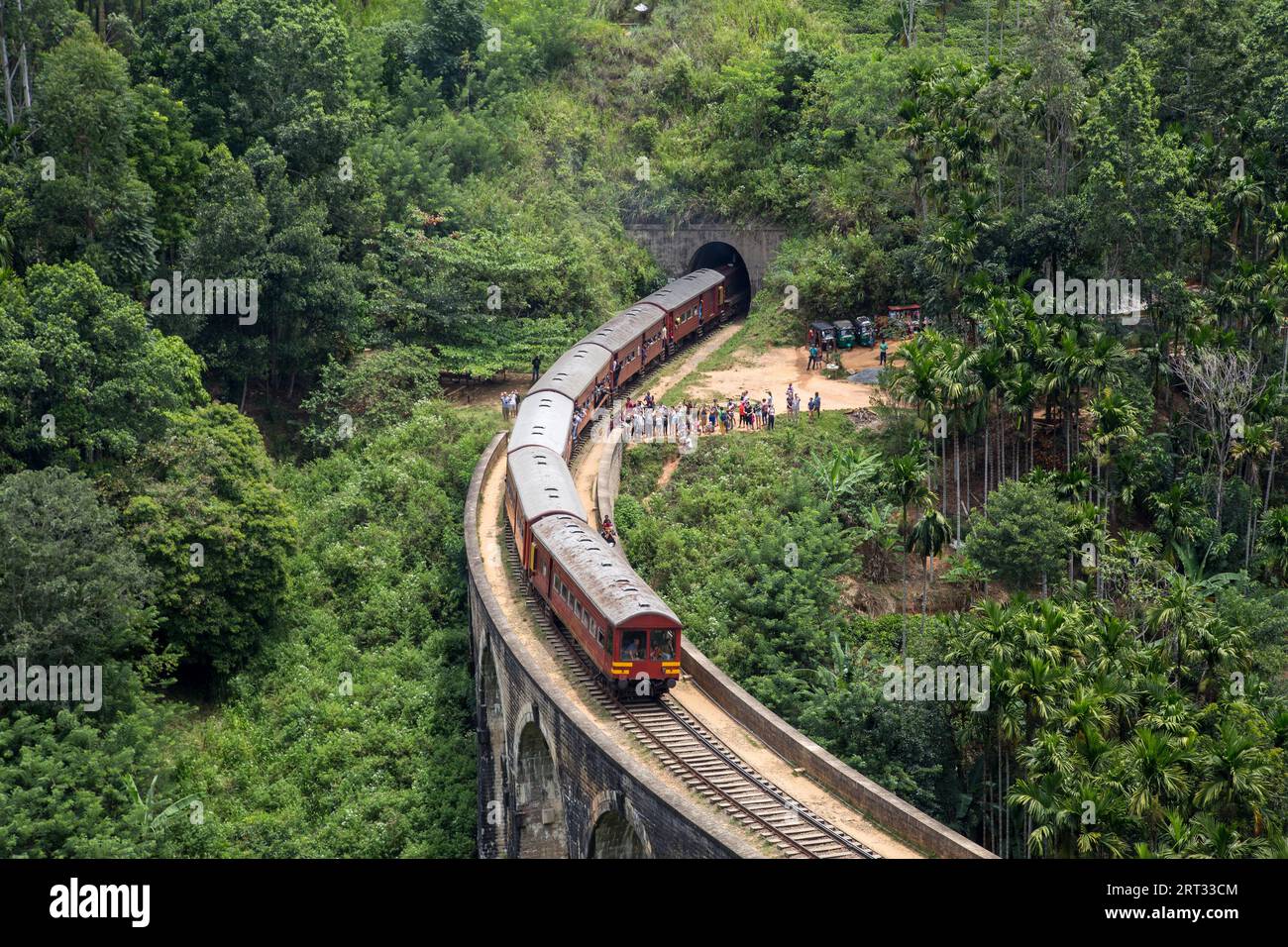 Demodara, Sri Lanka, August 4, 2018: A red train crossing the famous ...