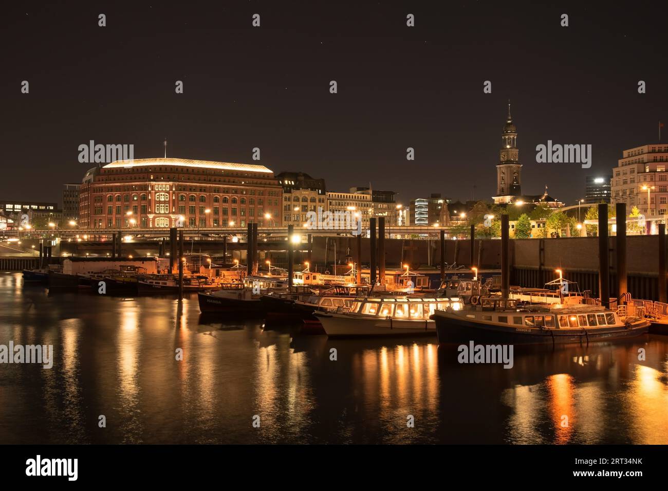 Harbour launch at the jetty at night Stock Photo - Alamy