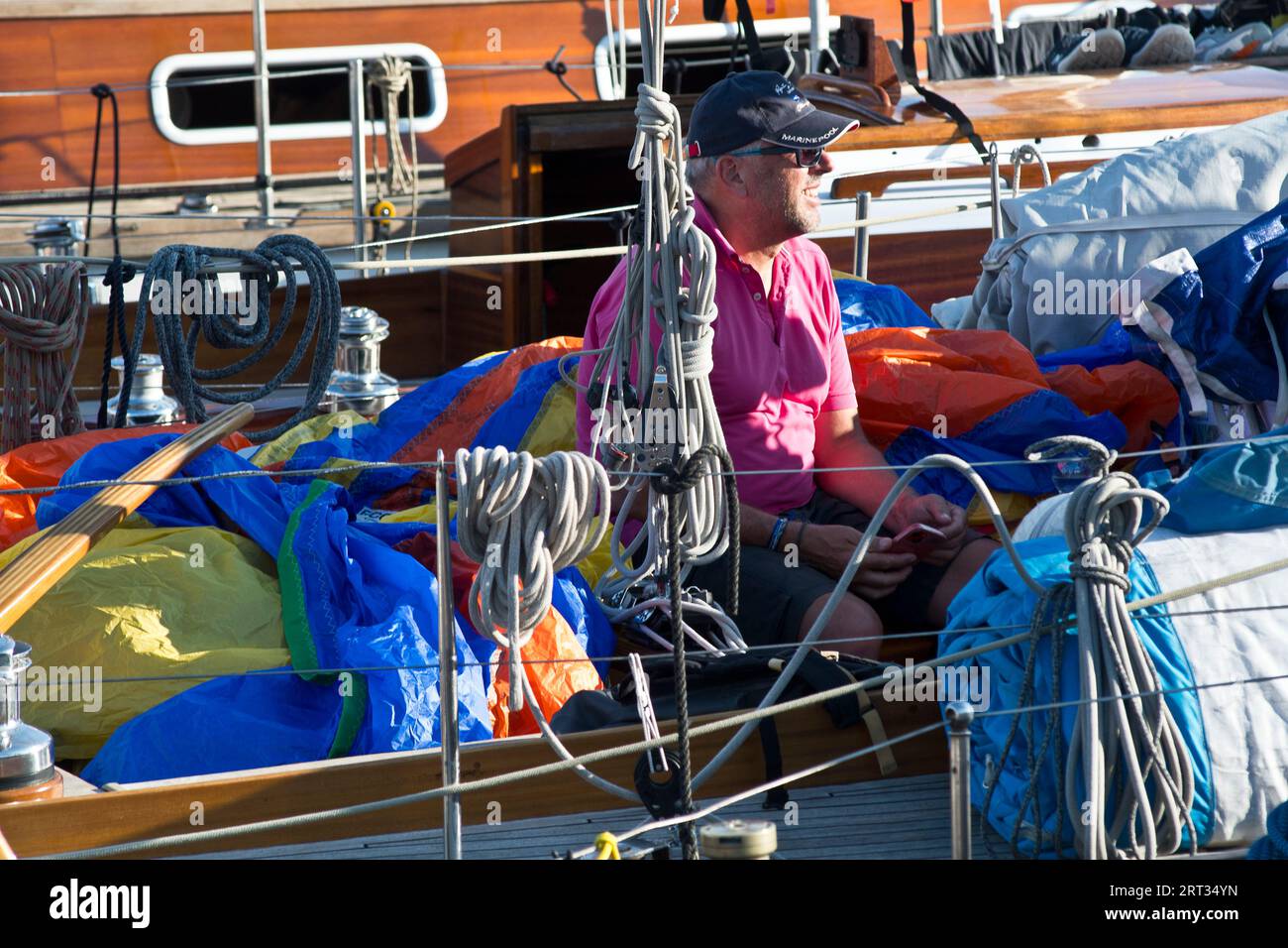 Crew member in cockpit surrounded by a mess of colorful sails - Vele d ...