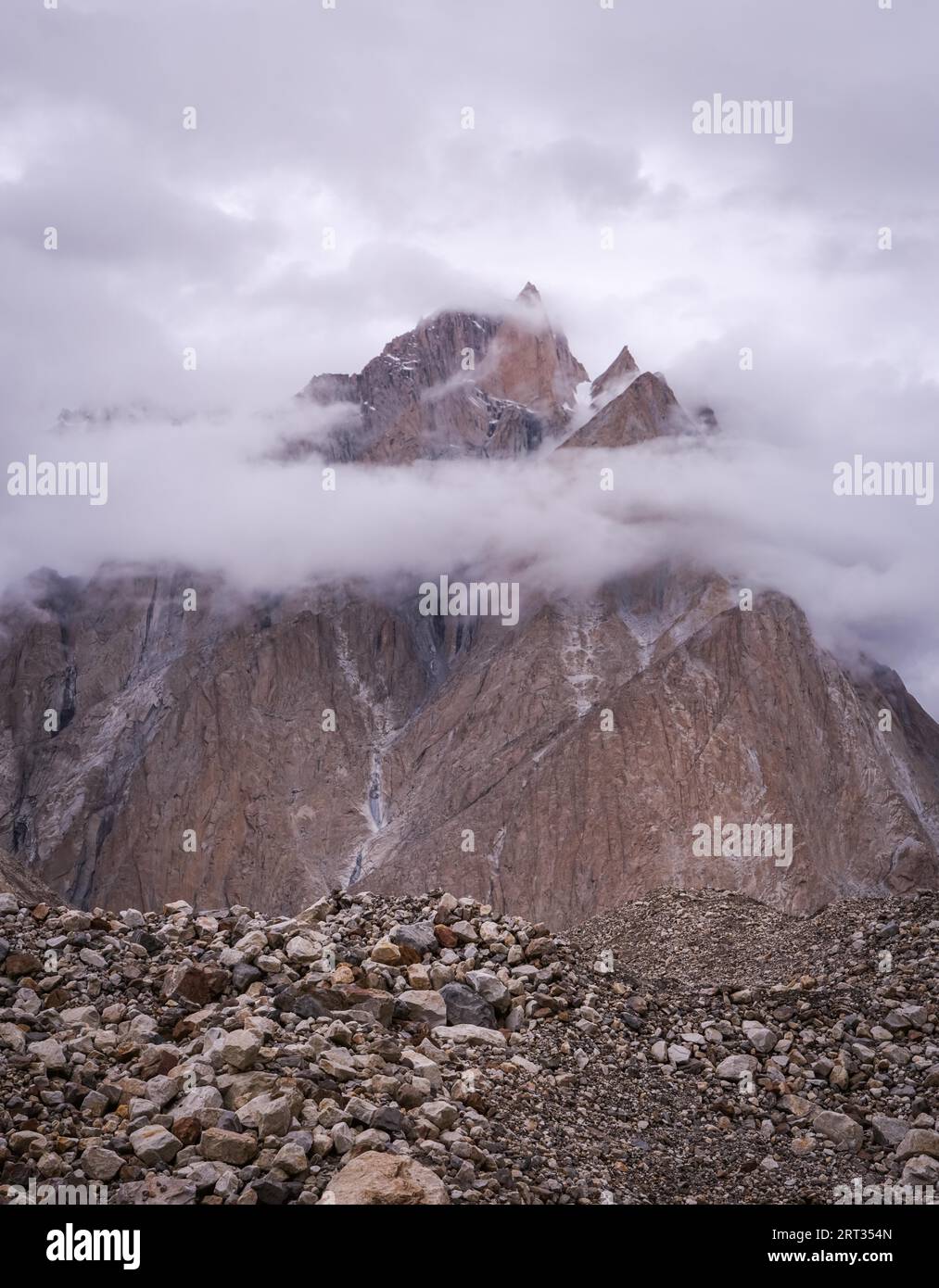 Beautiful peak of Trango Towers surrounded by white clouds in Karakoram ...